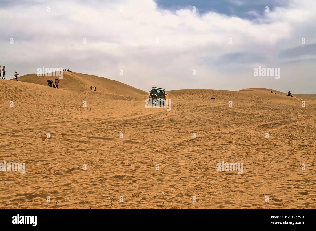 Yazd, Desert, Iran, February 20, 2021:People watch as an off-road tries ...