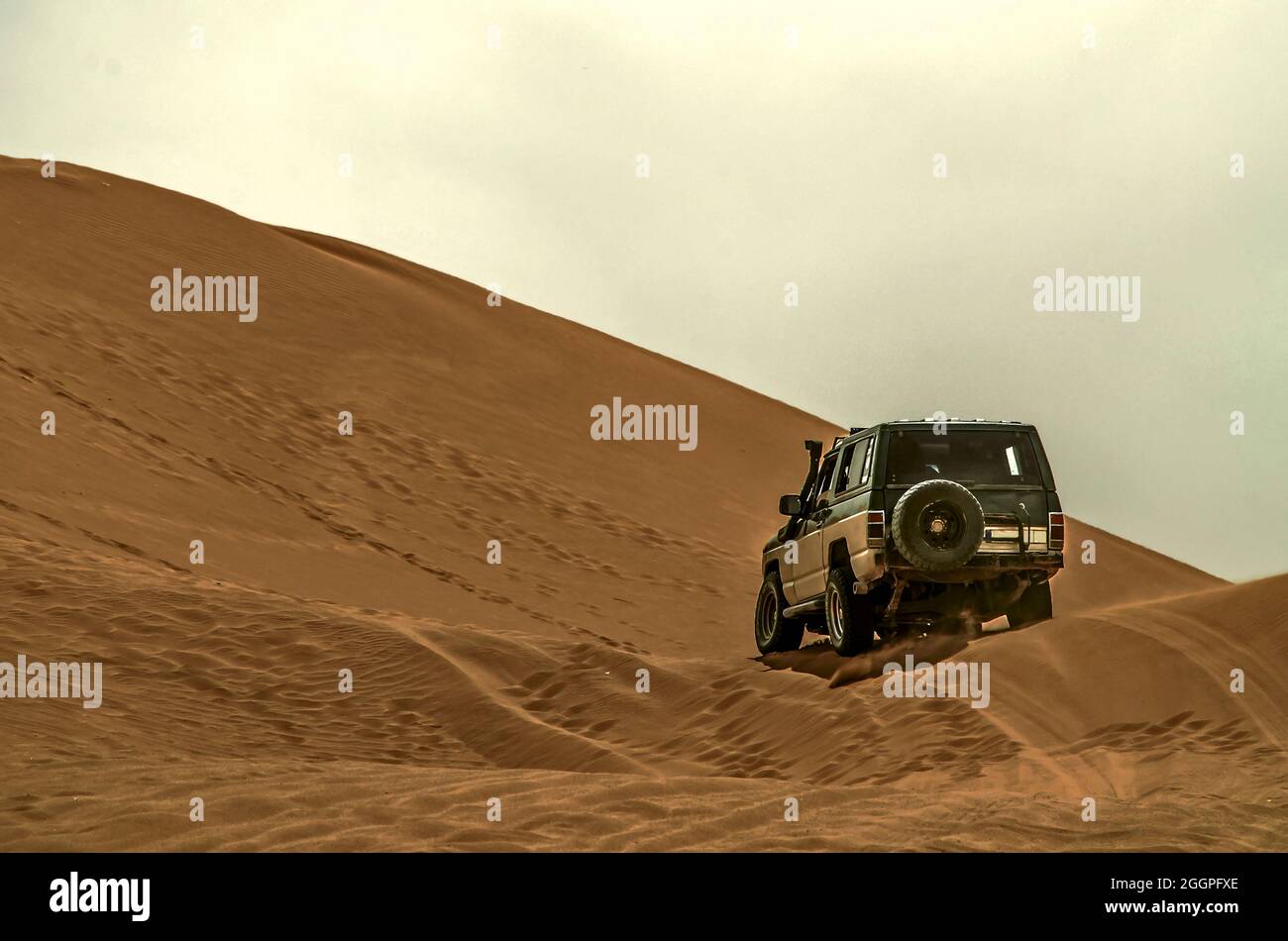 Yazd, Desert, Iran, February 20, 2021:An off-road tries to climb a hill ...