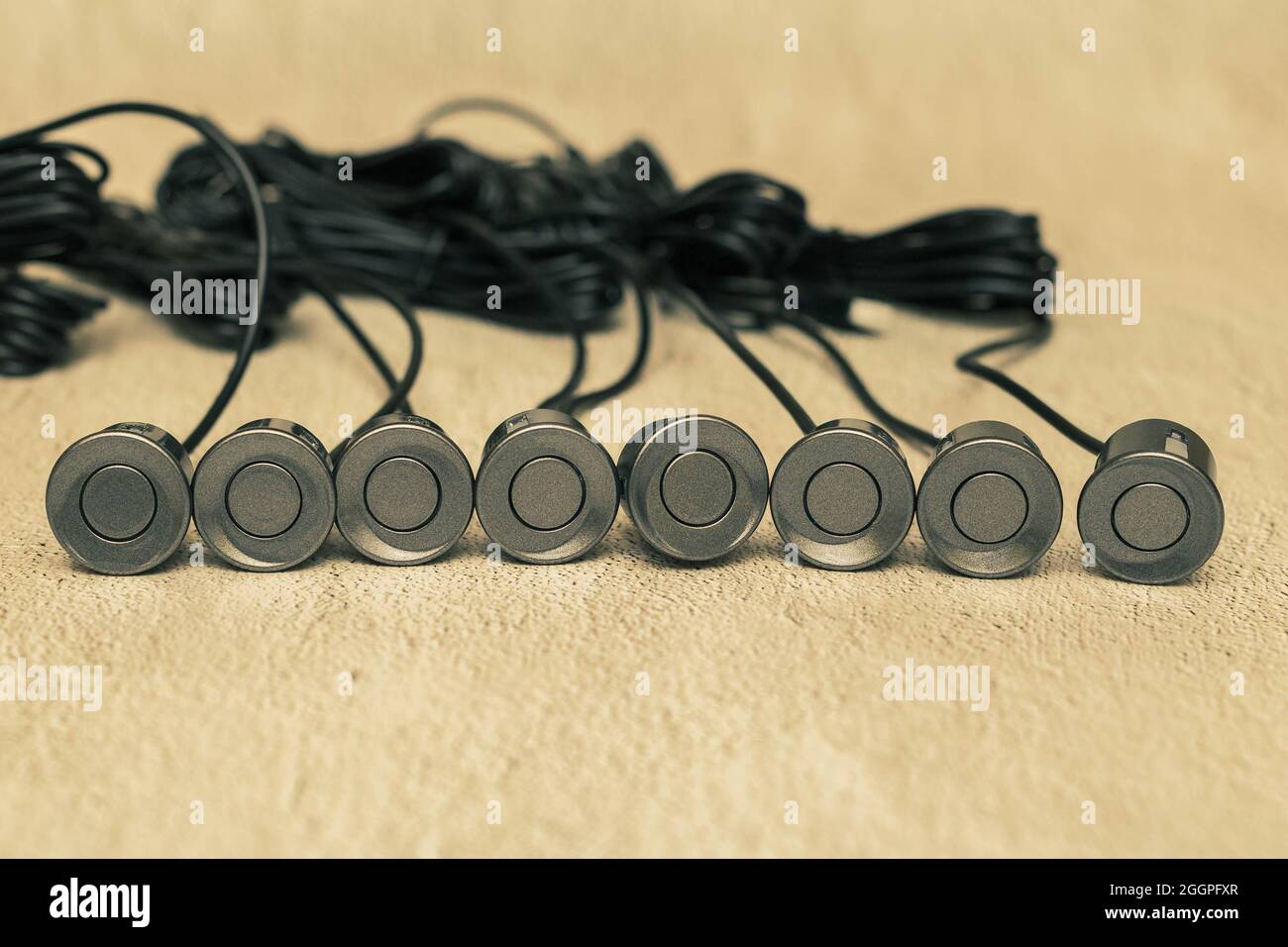 Grey parking sensors with wires on the concrete surface Stock Photo - Alamy