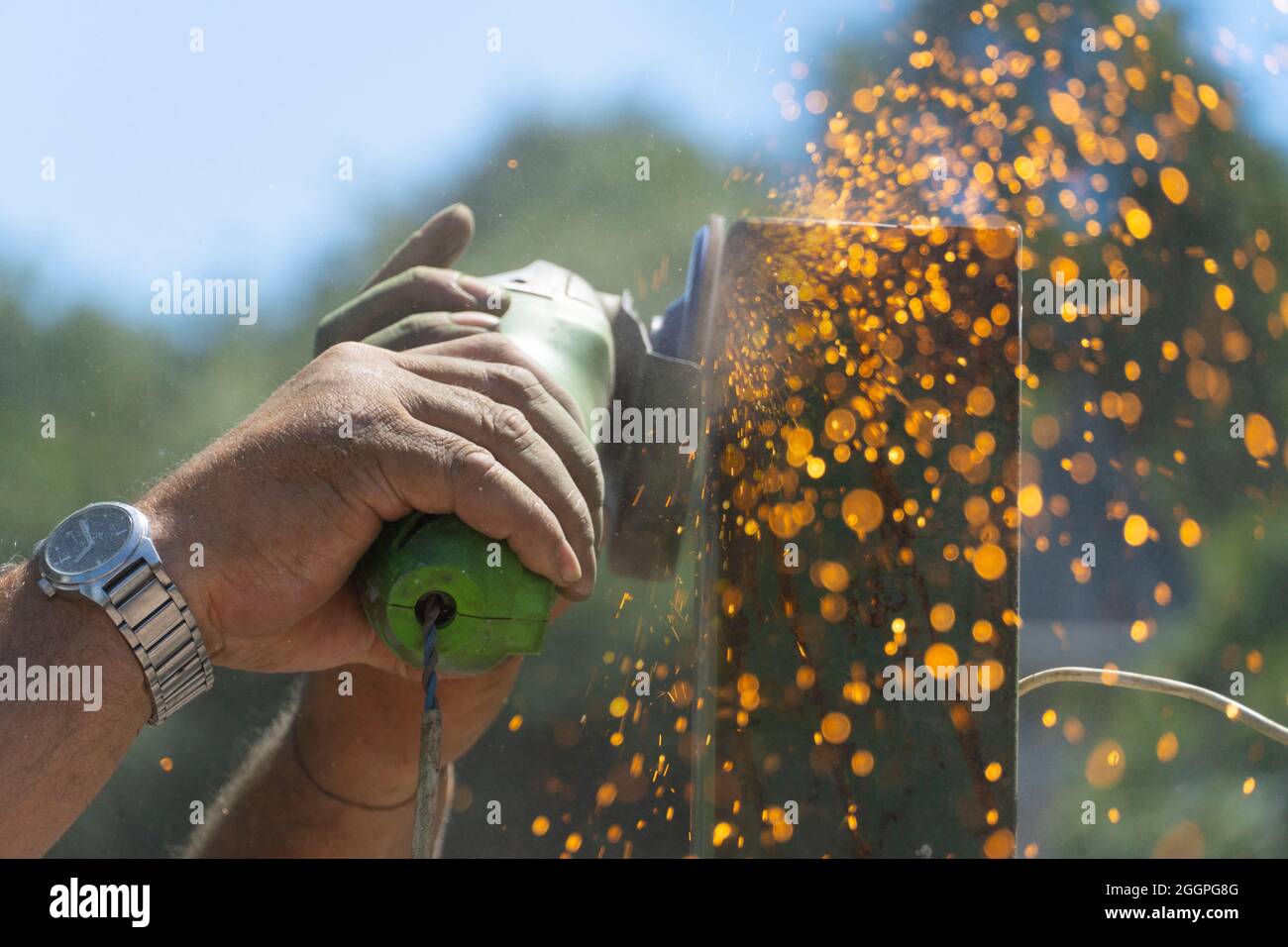 man uses flexible that makes sparks without using protective gloves ...