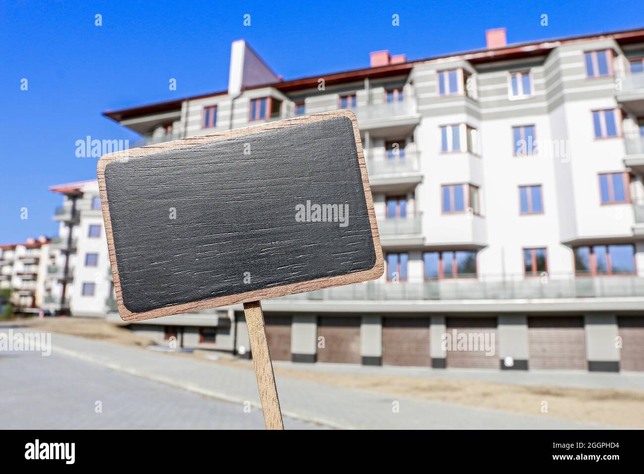 Blackboard label and a apartment building in the background, copy space ...