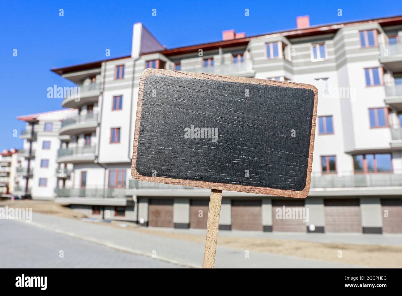 Blackboard label and a apartment building in the background, copy space ...