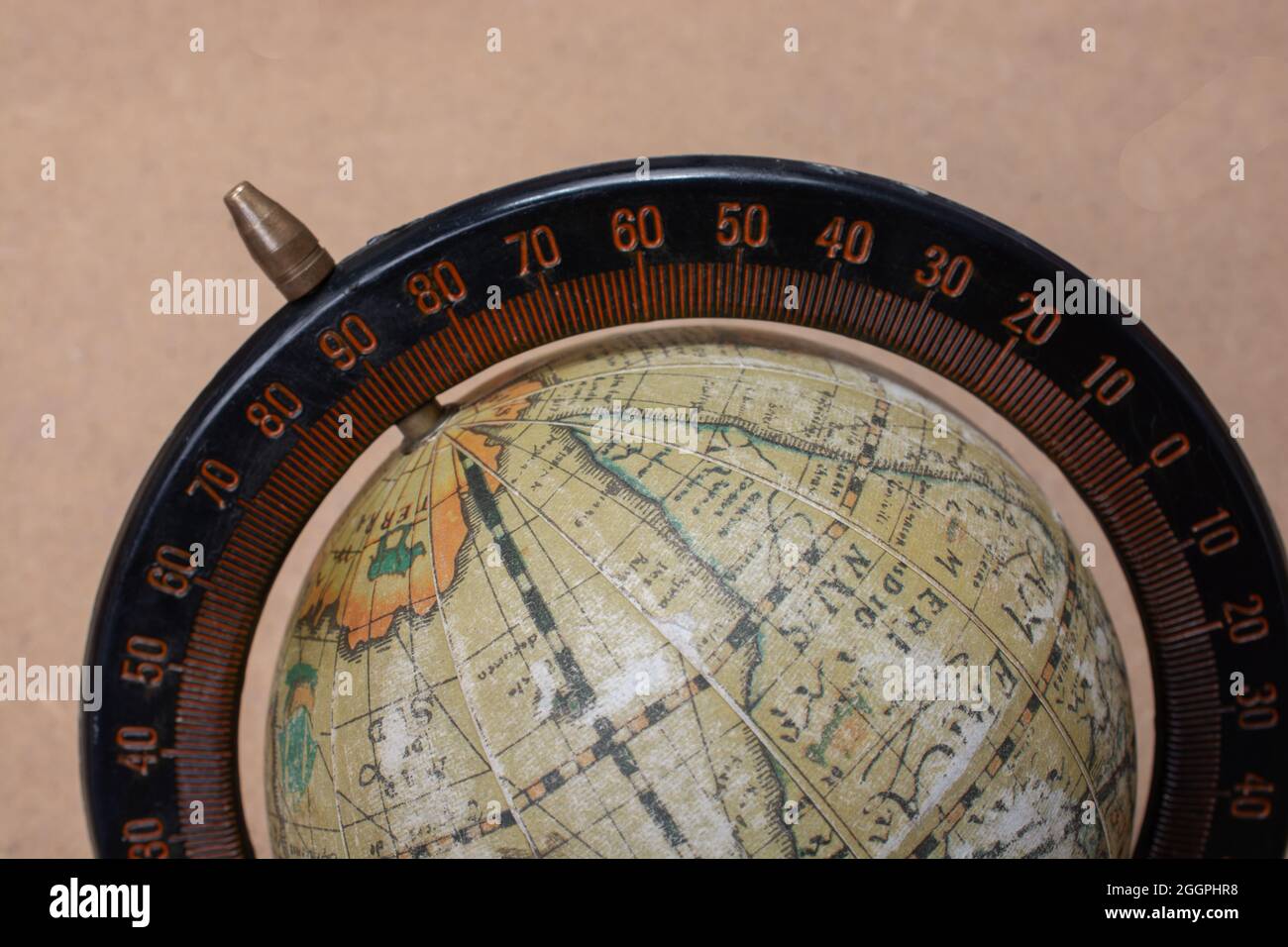 Closeup shot of a globe with numbers on a plain wall background Stock ...