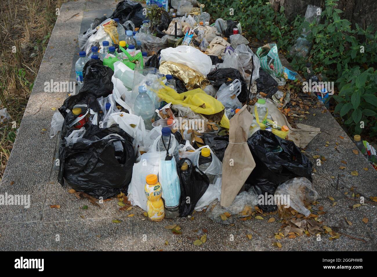 The garbage in the river with rock background Stock Photo - Alamy