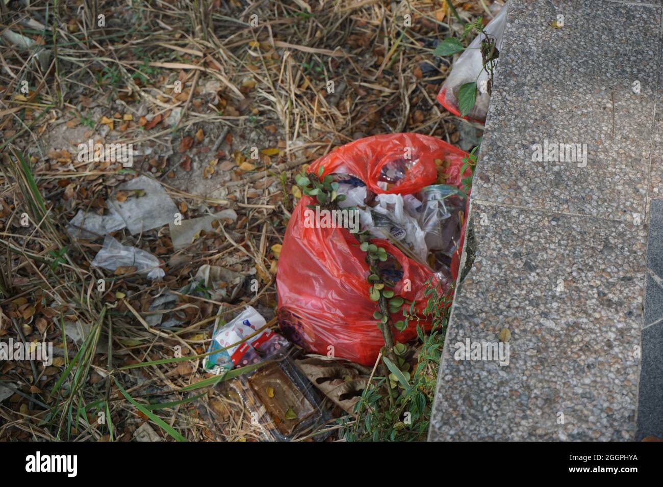 The garbage in the river with rock background Stock Photo - Alamy