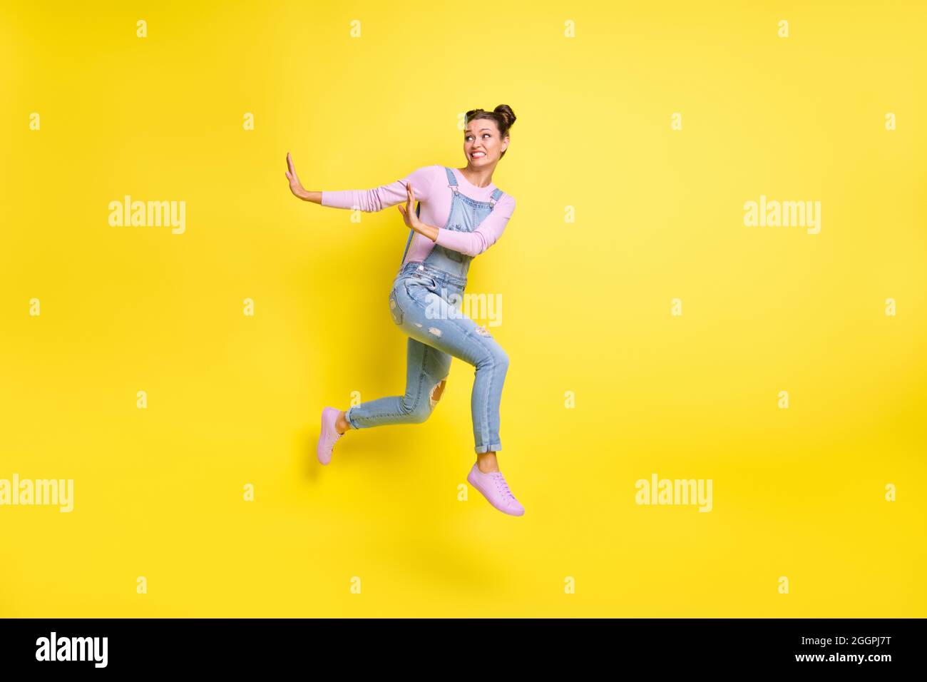 Photo of scared lady jump run away show stop sign wear jeans overall ...