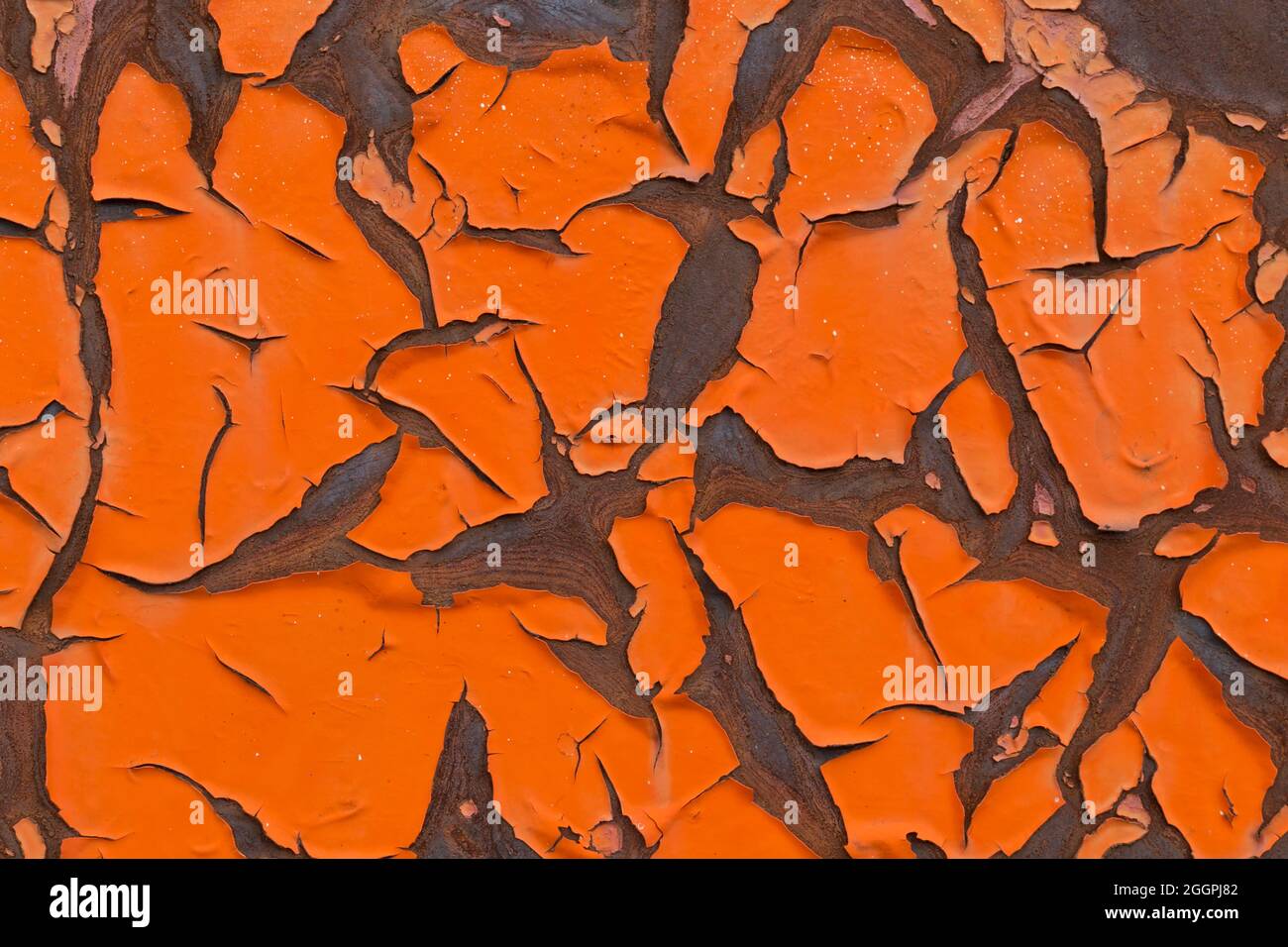 A metal bin with old orange peeling paint leaving interesting patterns ...