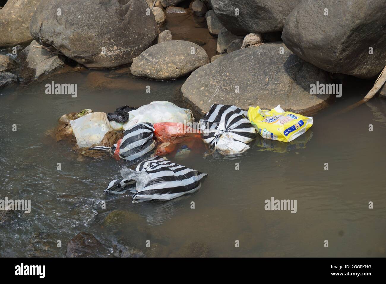 The garbage in the river with rock background Stock Photo - Alamy