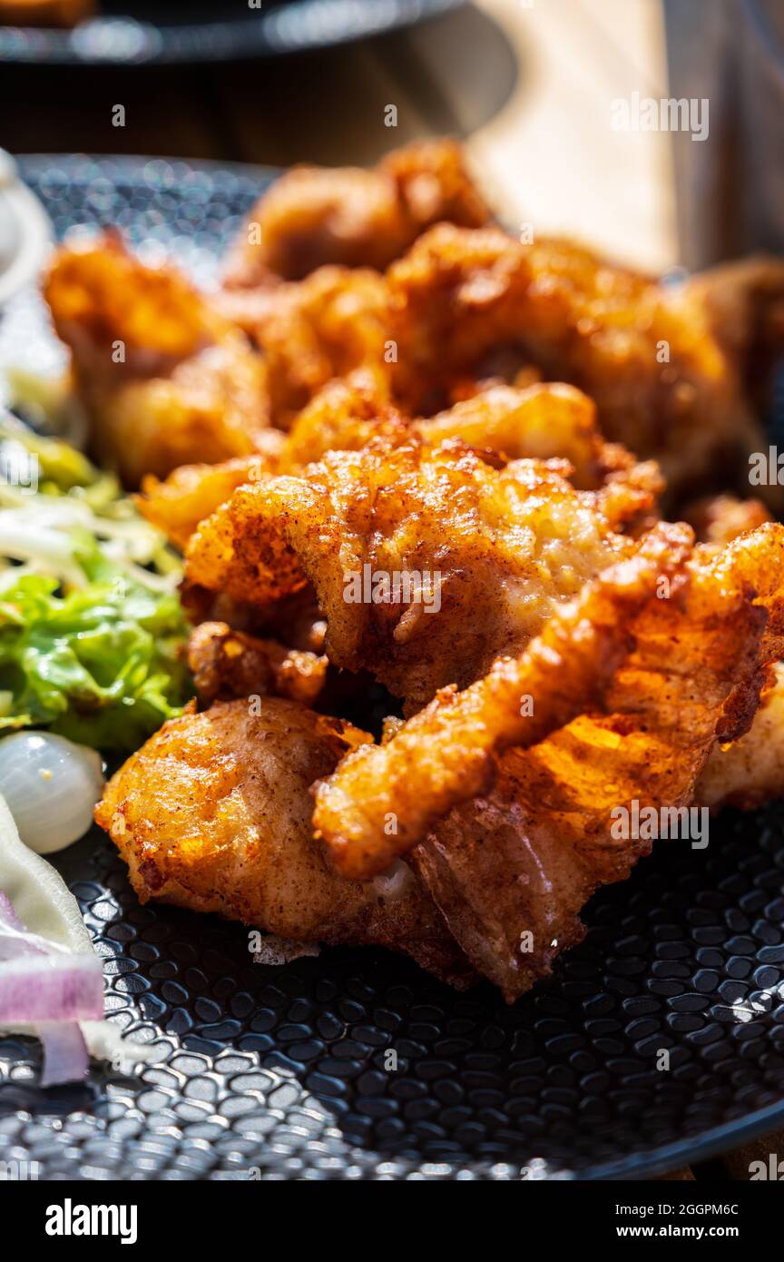 Dutch street food, fried pieces of cod fish fillet served with garlic ...