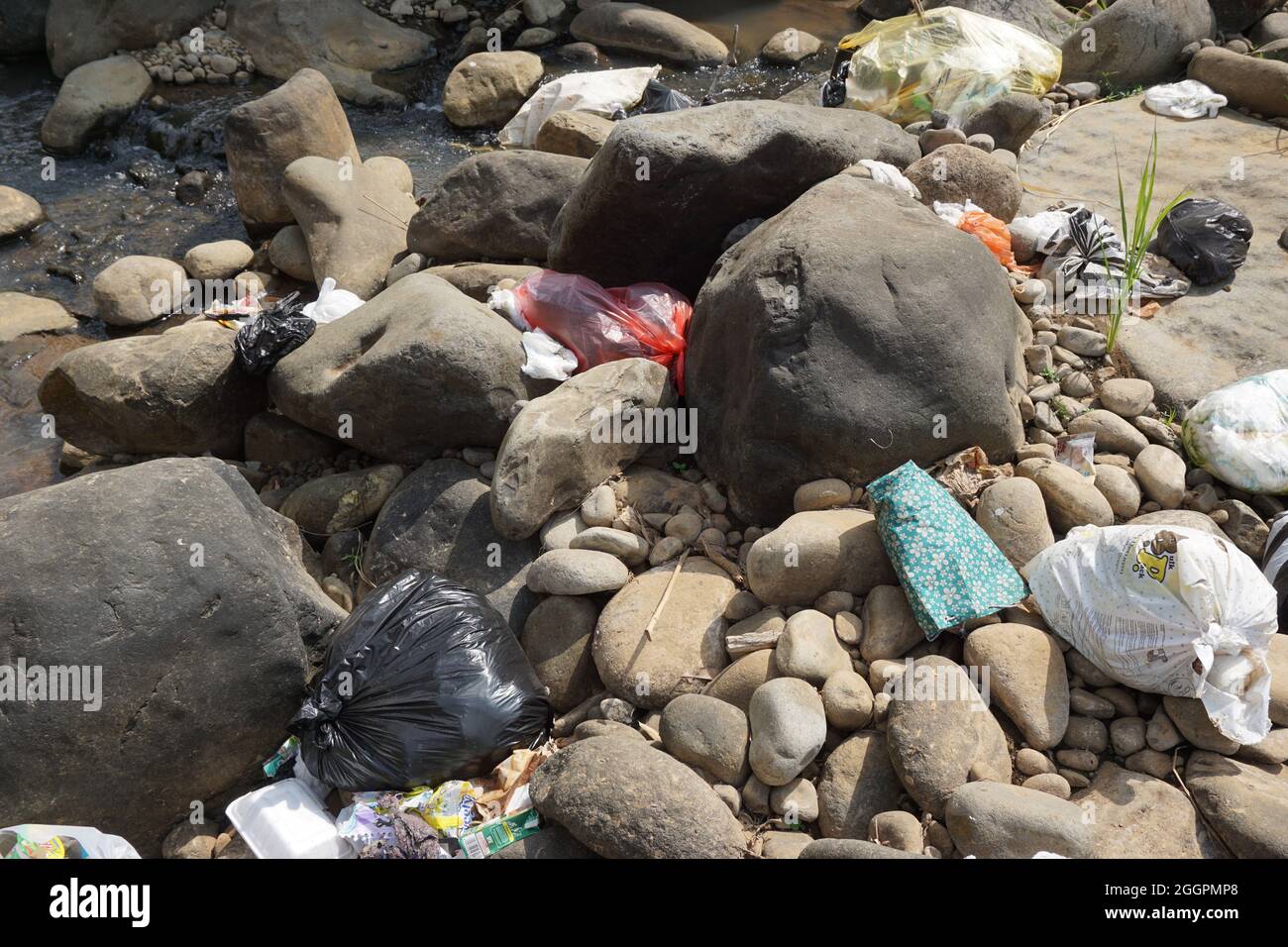 The garbage in the river with rock background Stock Photo - Alamy