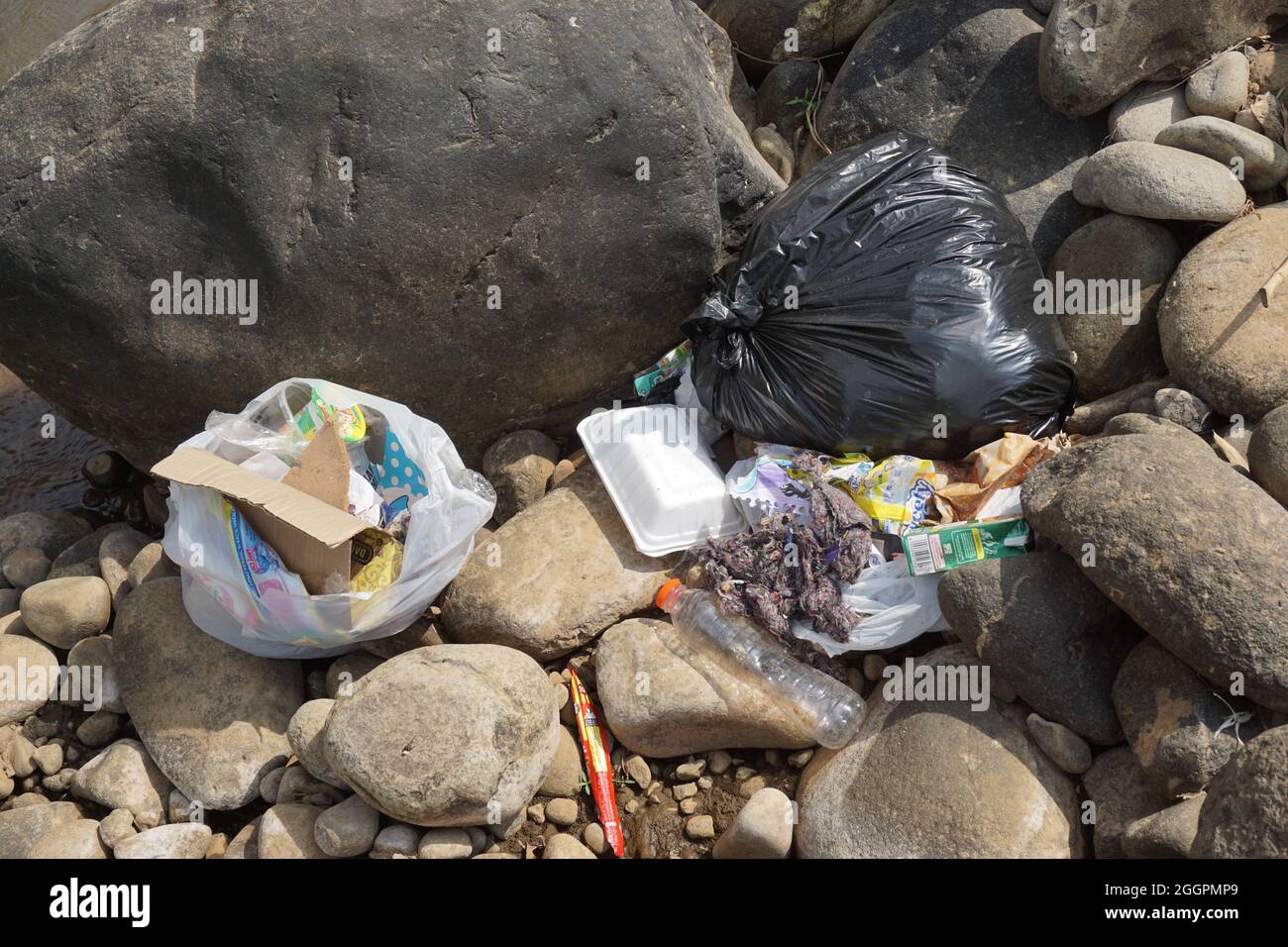The garbage in the river with rock background Stock Photo - Alamy