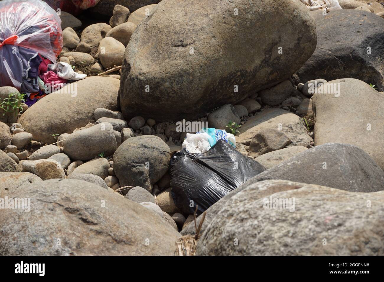 The garbage in the river with rock background Stock Photo - Alamy