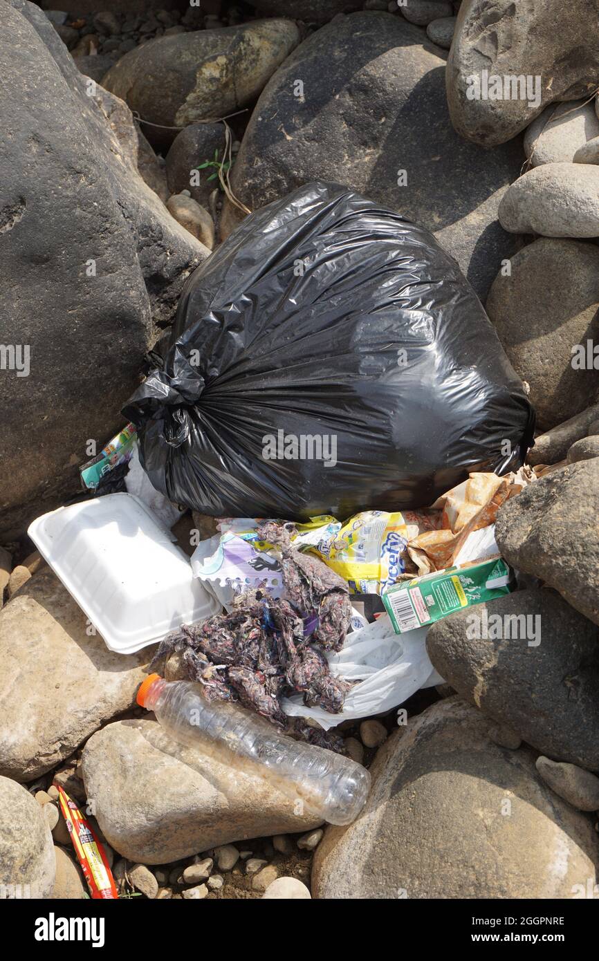The garbage in the river with rock background Stock Photo - Alamy