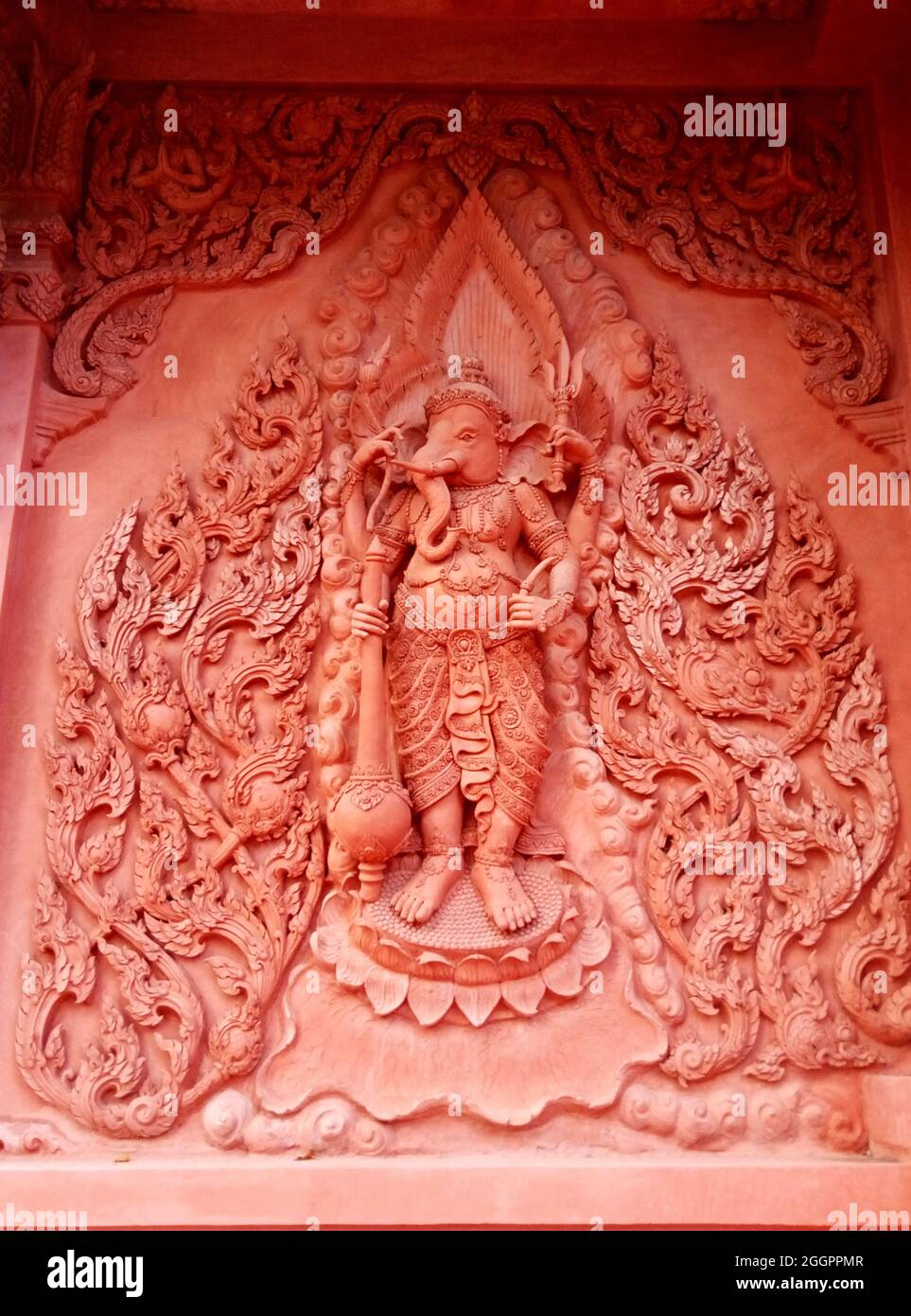 Temple of red color in Thailand. The facade of the temple is decorated ...