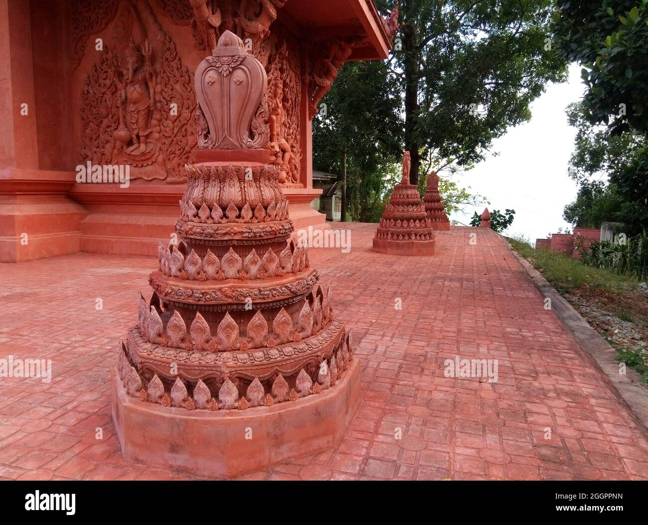 Temple of red color in Thailand. The facade of the temple is decorated ...