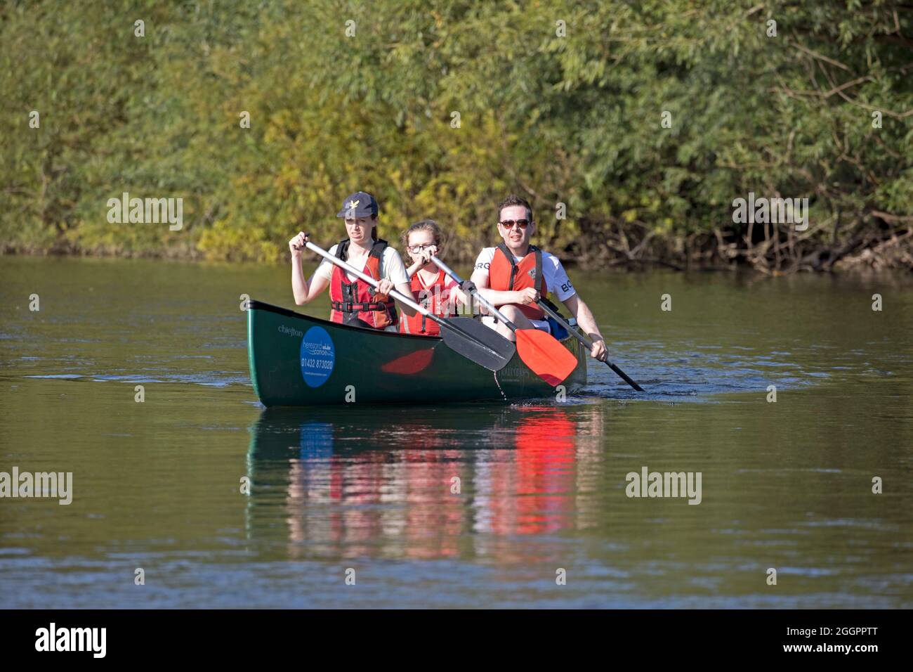Family in Canadian canoe on River Wye at Hoarwithy, Herefordshire, UK ...