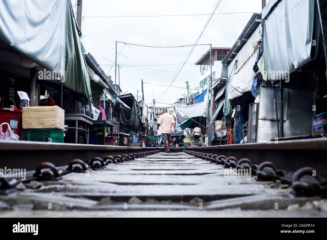 BANGKOK, THAILAND - Mar 07, 2019: A man walking on the railway track ...