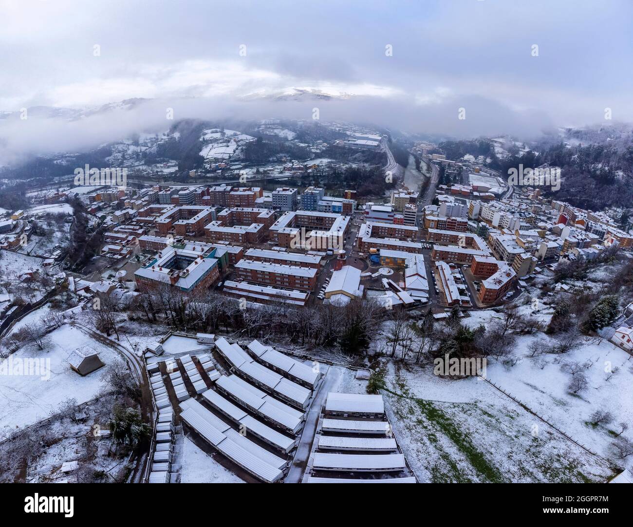 Aerial view of the Asturian town of Blimea under a snowfall, Spain ...