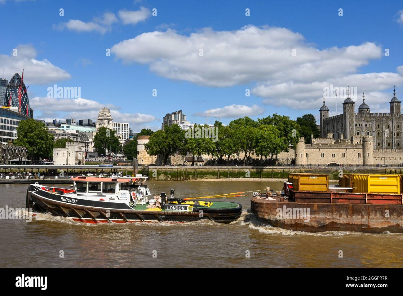 London, England - August 2021: Industrial barge pulling an industrial ...