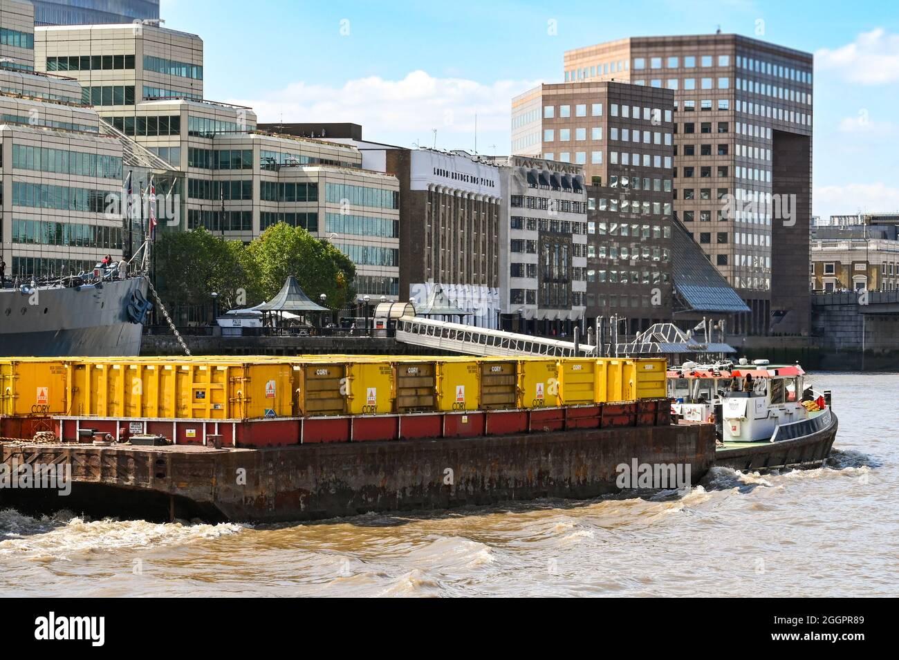 London, England - August 2021: Industrial barge pulling an industrial ...