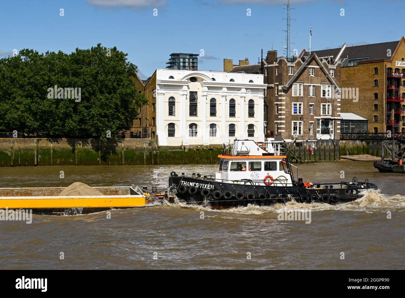 London, England - August 2021: Industrial barge pushing an industrial ...