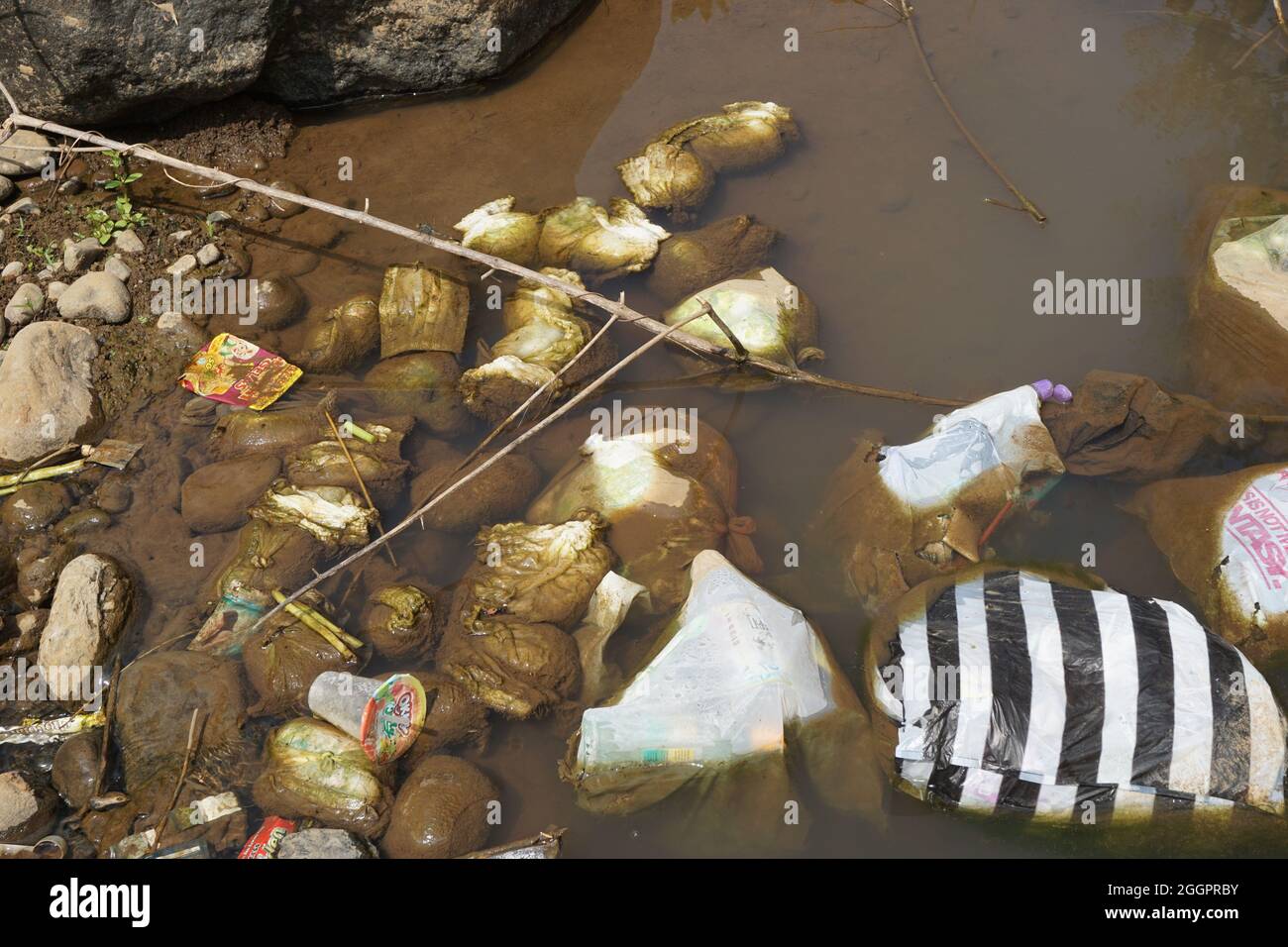 The garbage in the river with rock background Stock Photo - Alamy