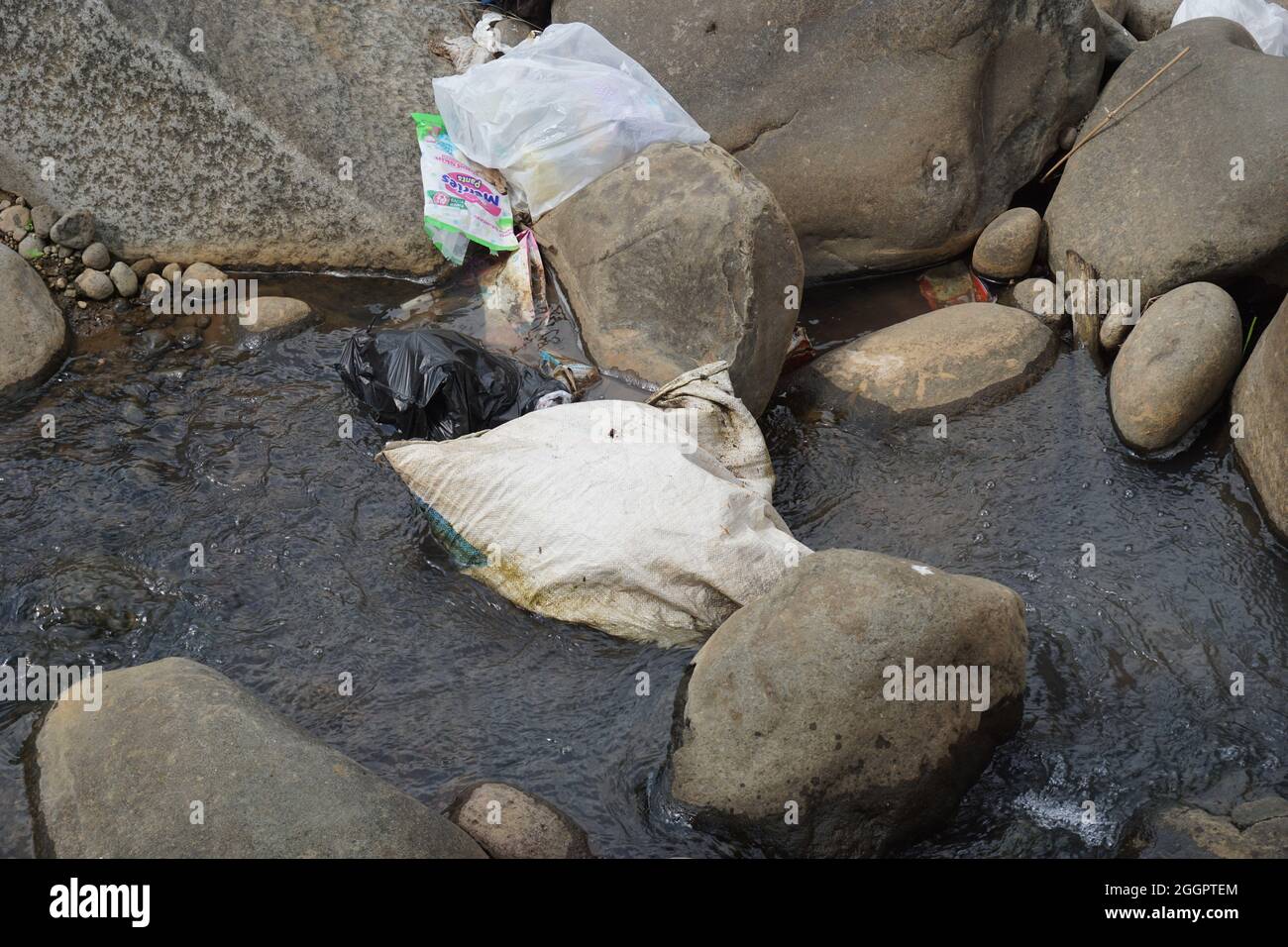 The garbage in the river with rock background Stock Photo - Alamy