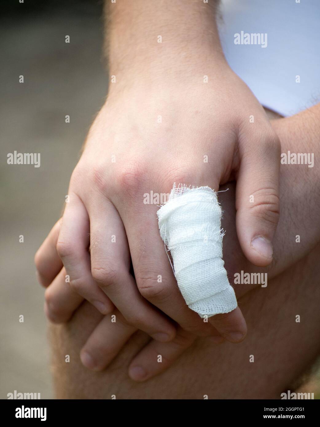 Teenager's bandaged finger after cut Stock Photo - Alamy