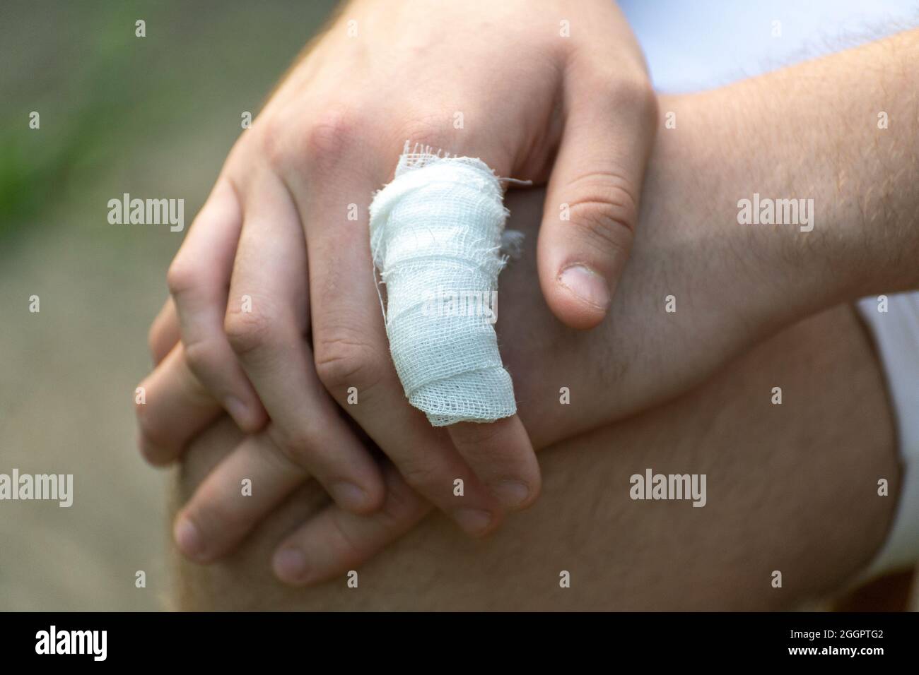 Teenager's bandaged finger after cut Stock Photo - Alamy