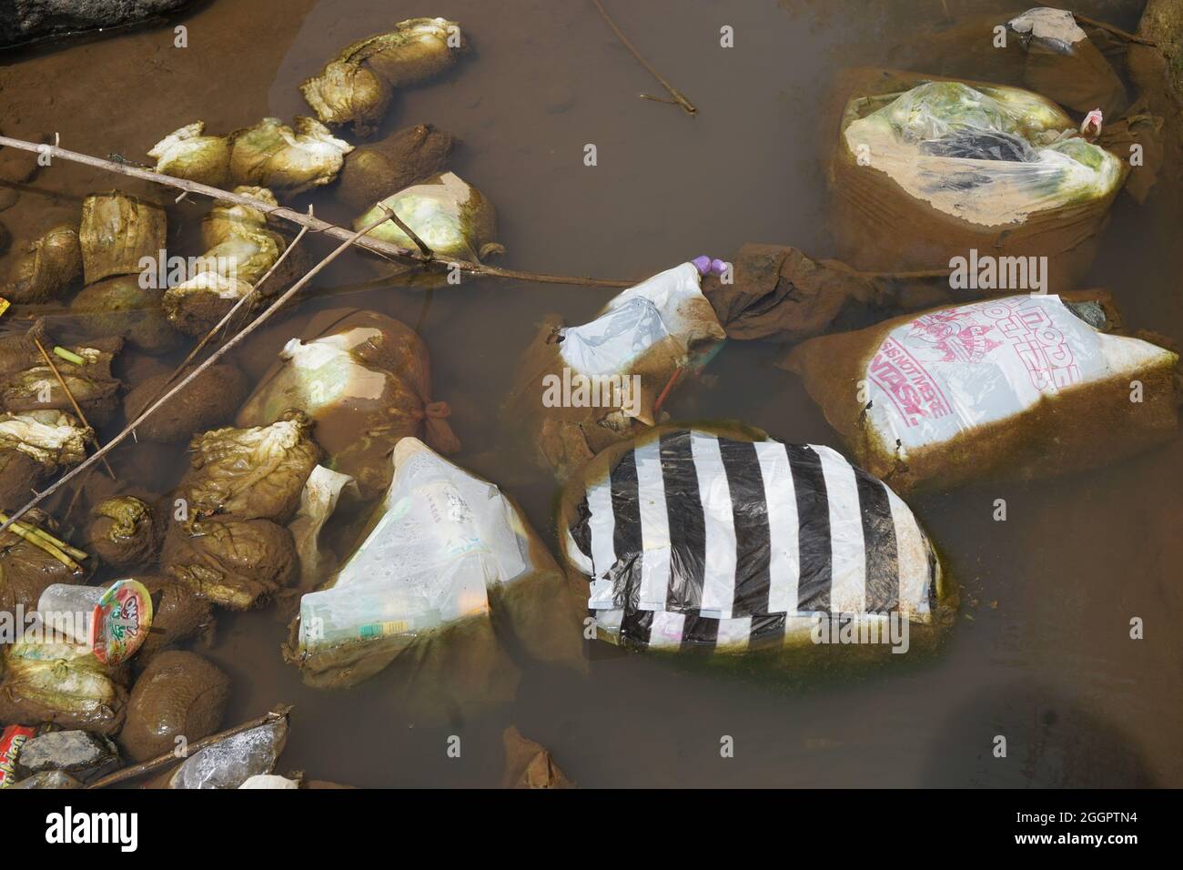 The garbage in the river with rock background Stock Photo - Alamy