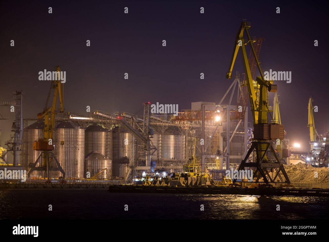 Port grain elevator in night time. Industrial sea trading port bulk ...