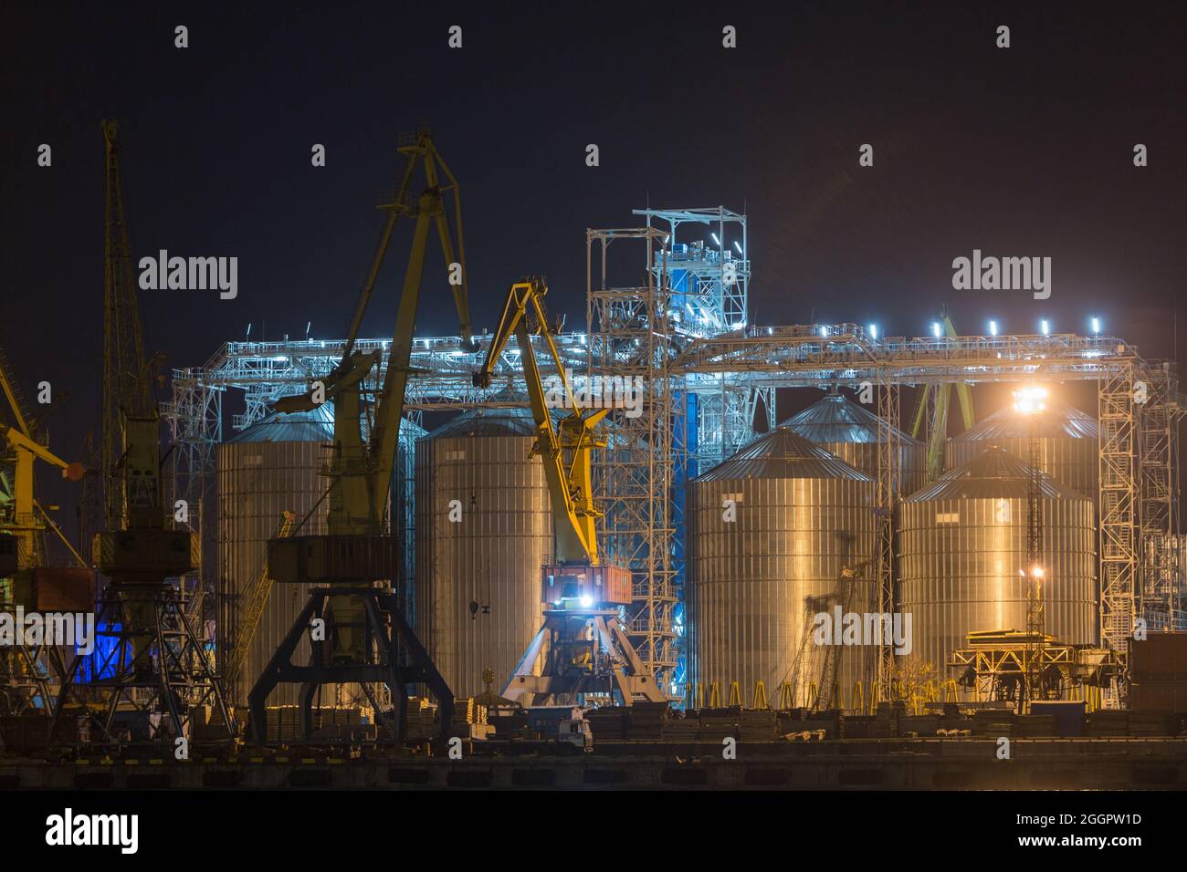 Port grain elevator in night time. Industrial sea trading port bulk ...