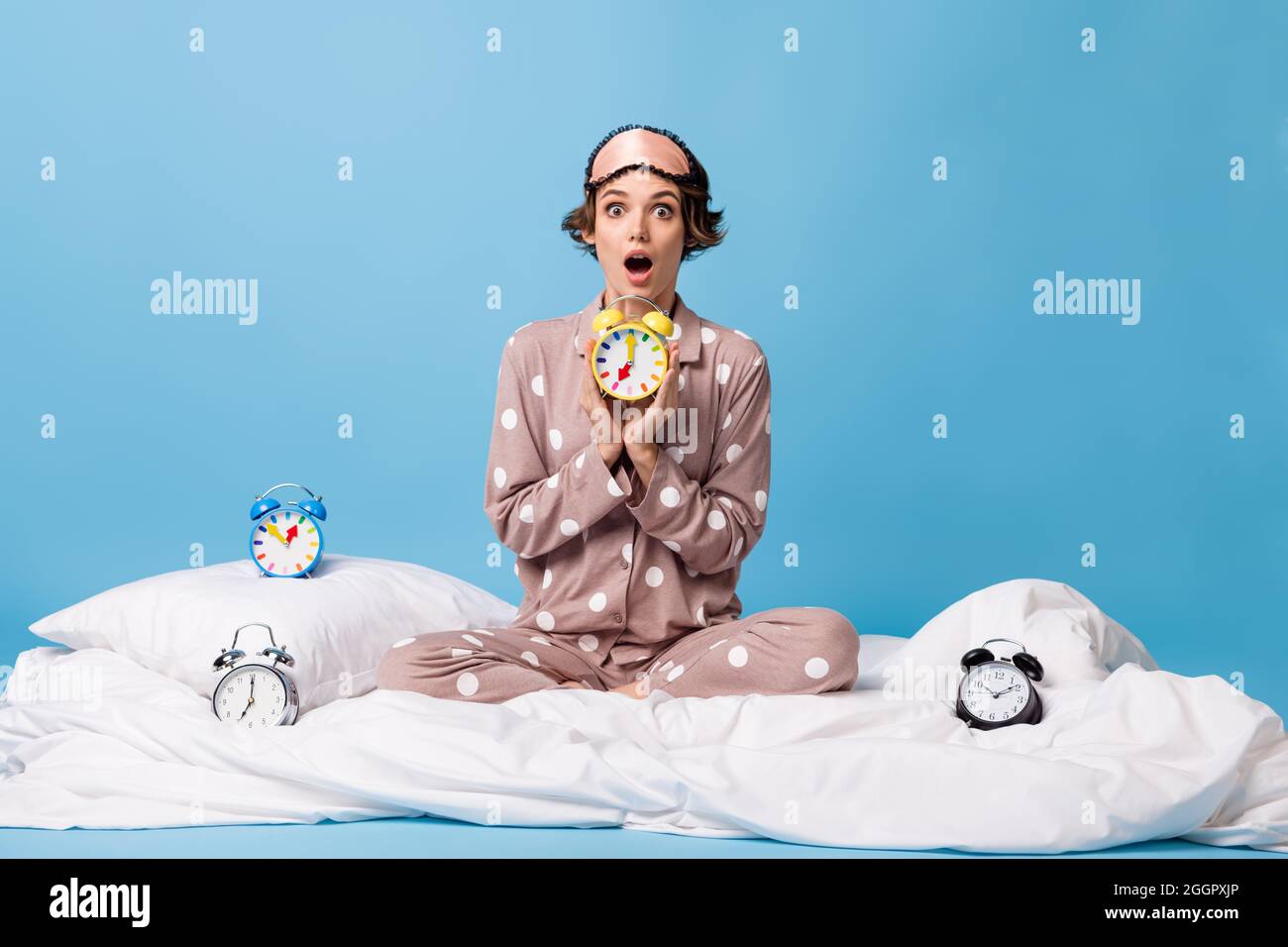 Full body photo of young girl amazed shocked oversleep late hold clock ...