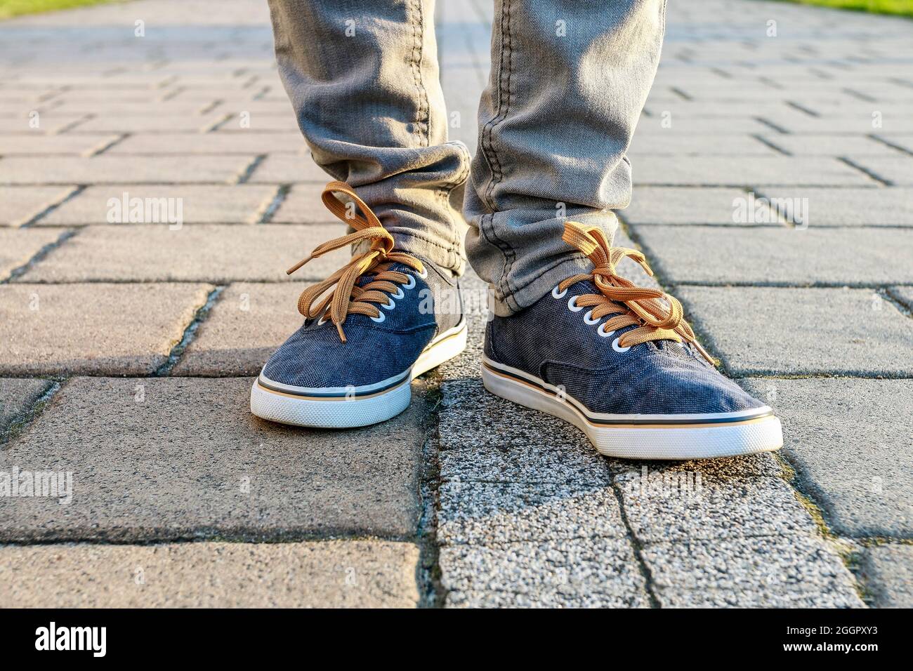 Young person wearing sneakers, walking on the pavement. Walk time Stock ...