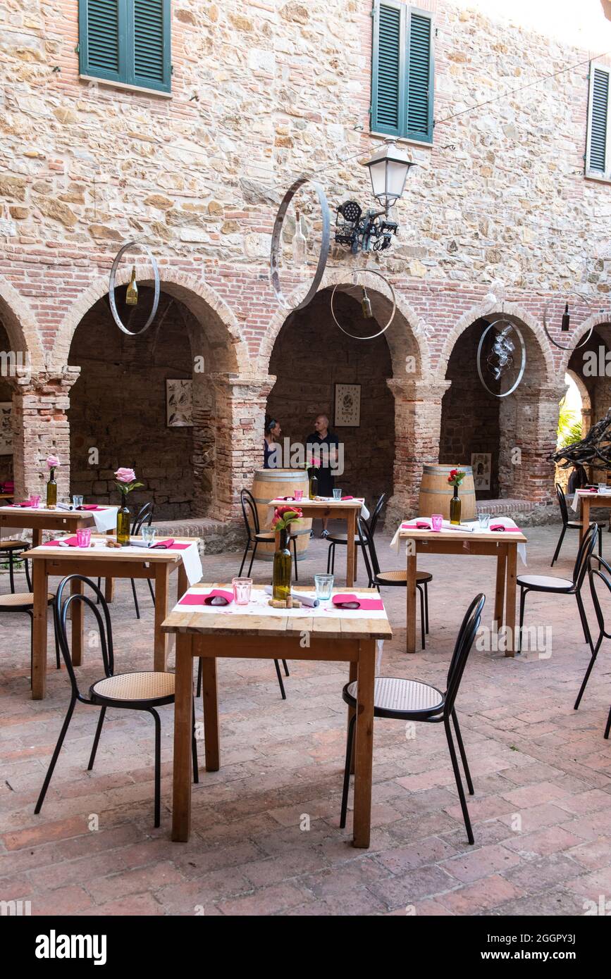 Suvereto. Cloister detail with tables . Special event Stock Photo - Alamy