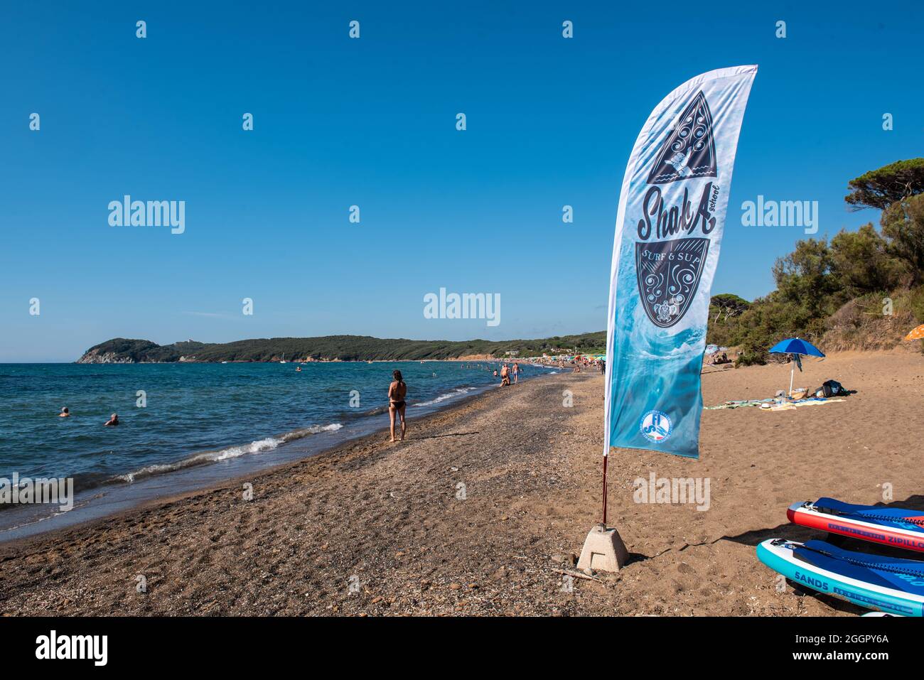 Baratti beach with a commercial flag Stock Photo - Alamy