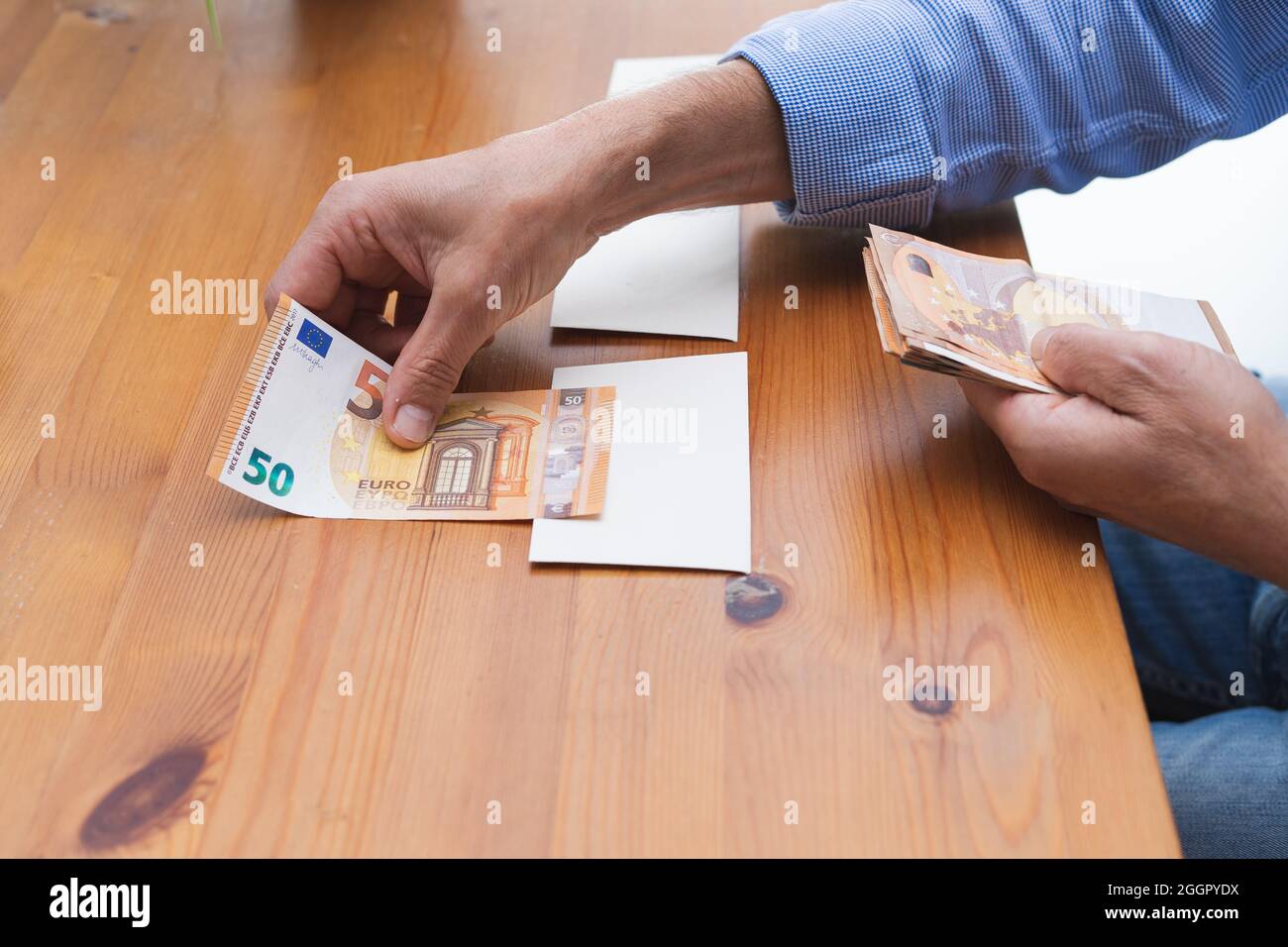 Man distributing paper money for different monthly expenses. Copy space ...