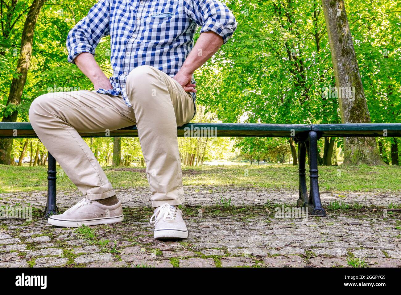 Angry man sitting on the bench in beautiful summer park Stock Photo - Alamy
