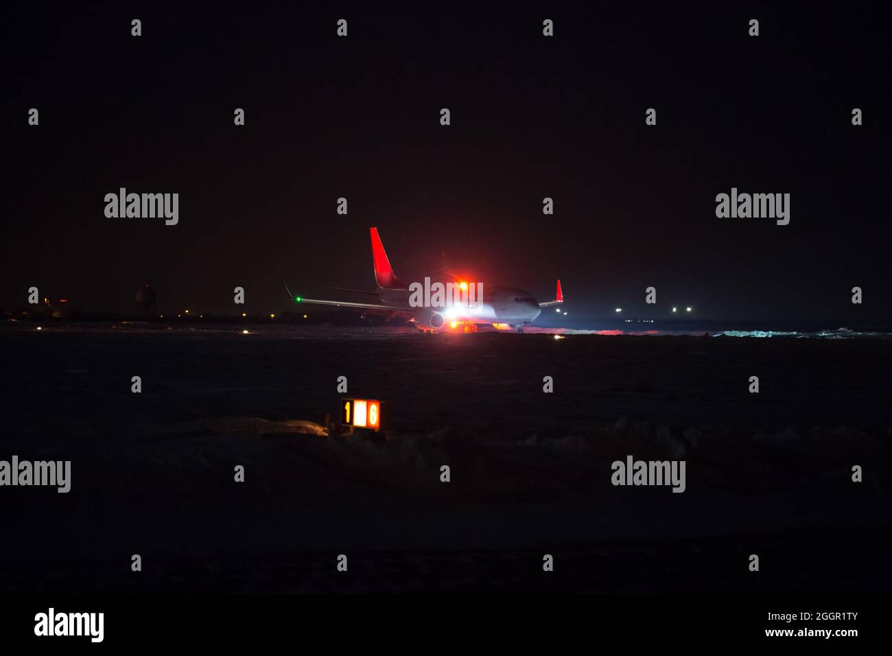 Passenger aircraft at night at airport. Airplane in winter at night at ...