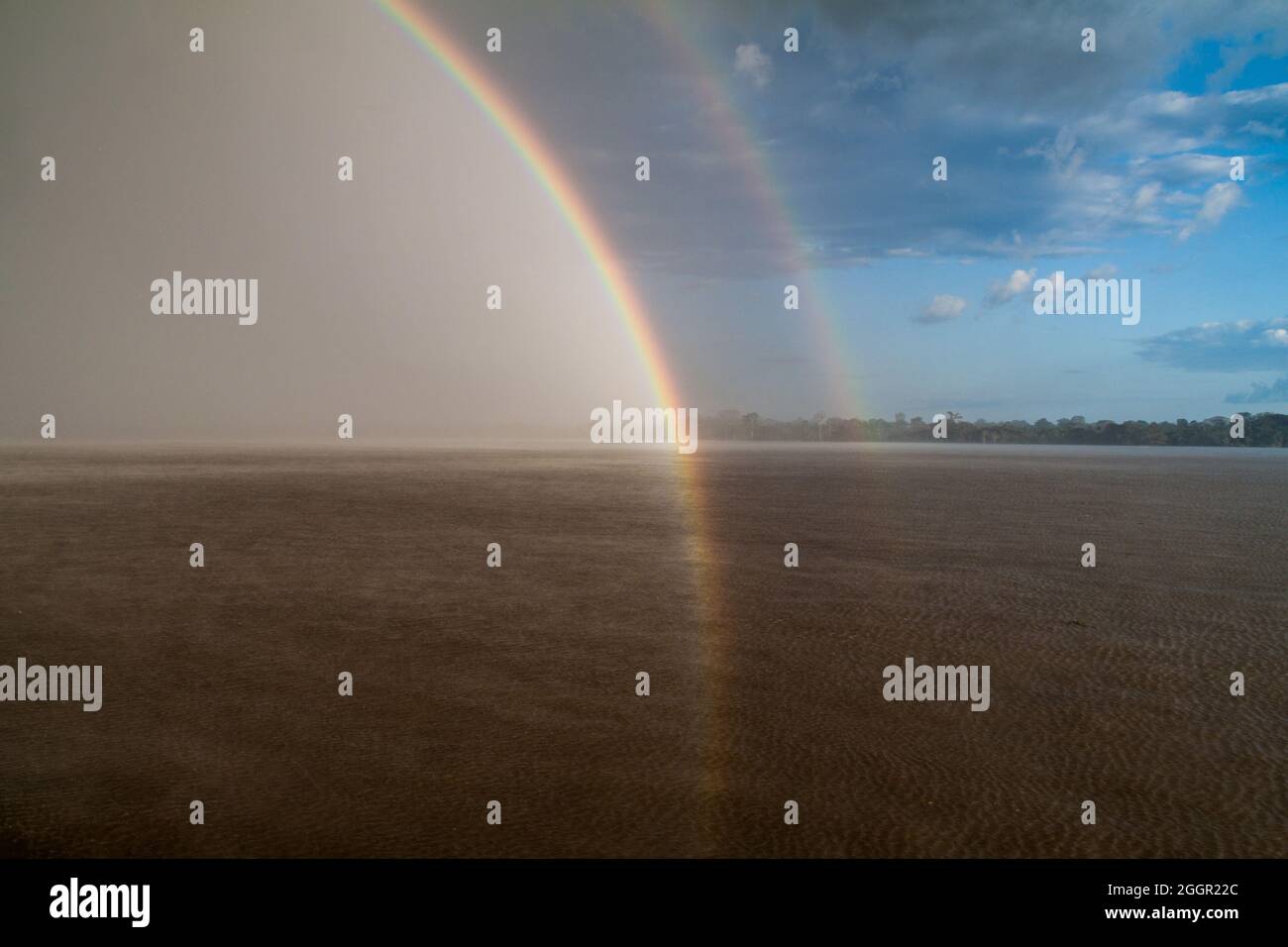 Rainbow over river Amazon in Brazil Stock Photo - Alamy