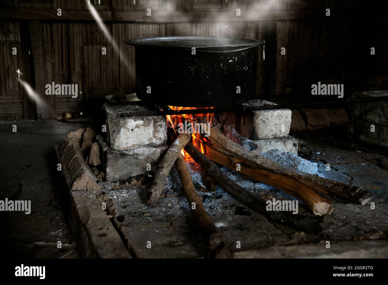 Cooking large pot over firewood inside a hut Stock Photo - Alamy