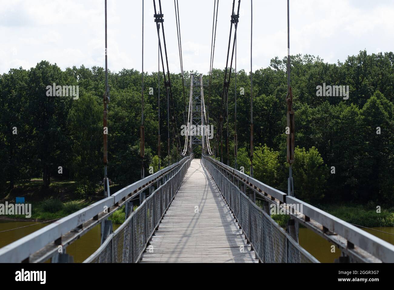 Pedestrian suspension bridge over river Neman in Mosty, Belarus. The ...