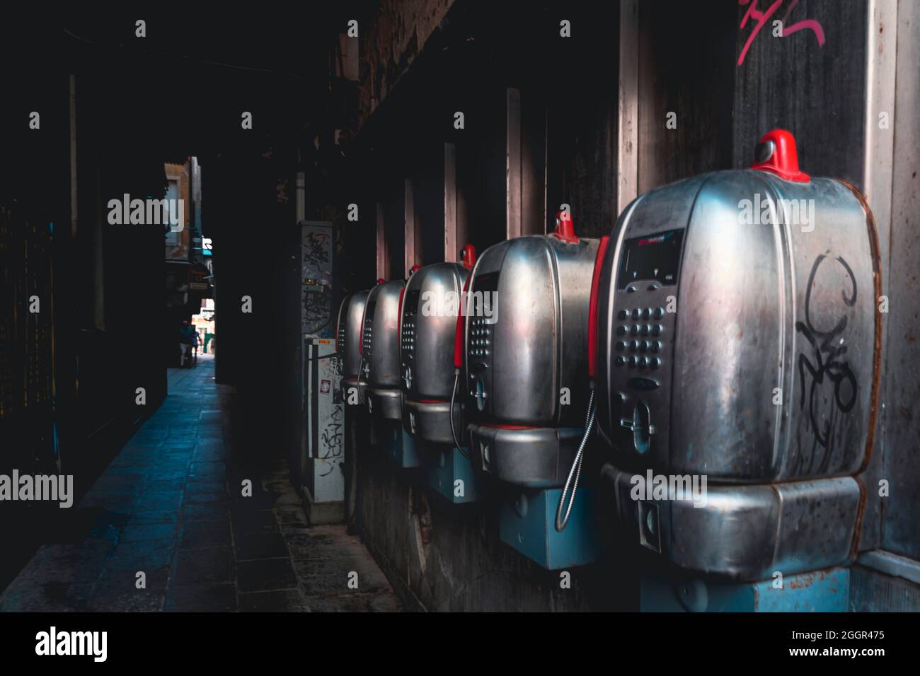 old telecom italia pay phones in a historic alley of the old city, soft ...