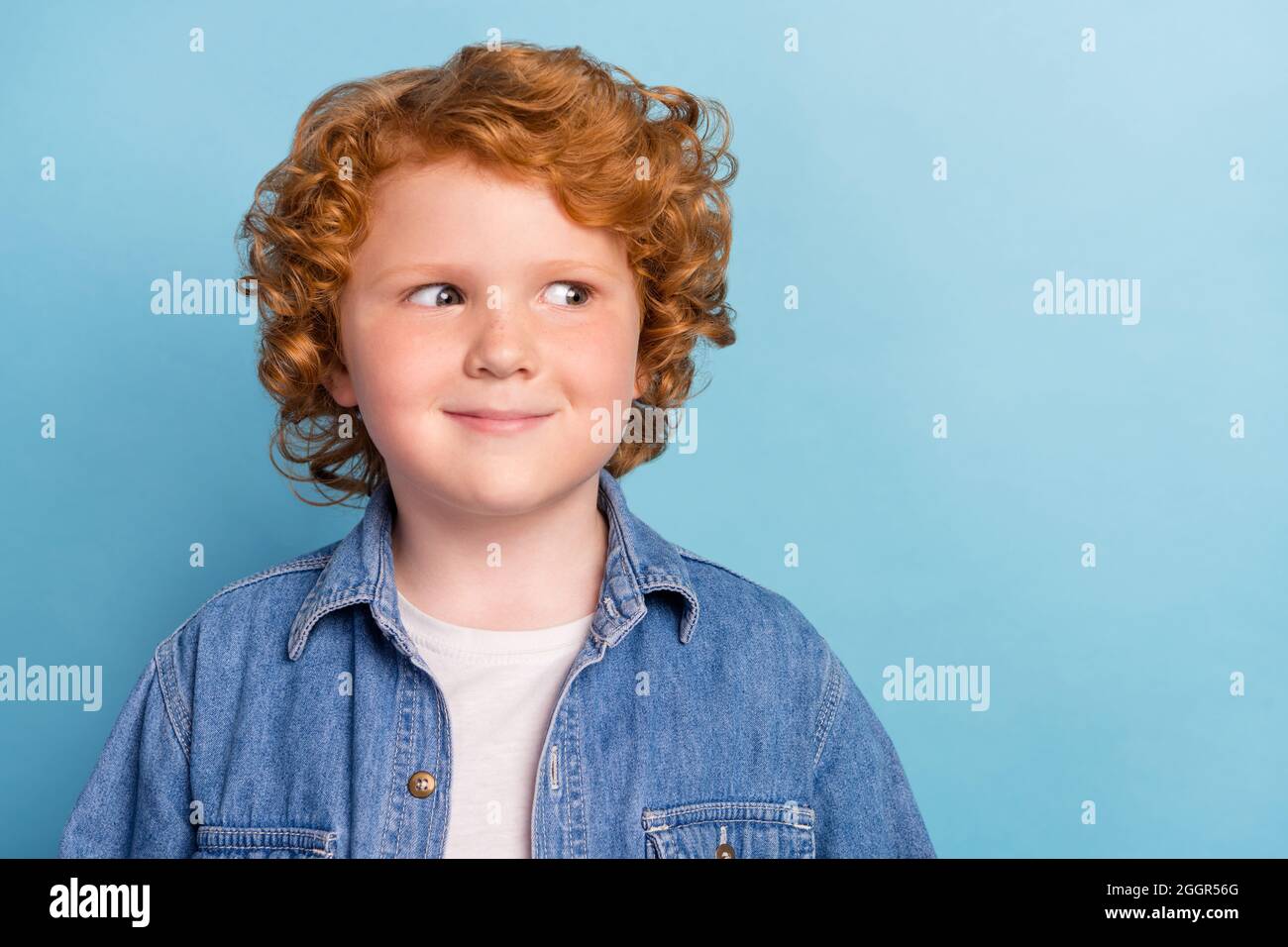 Photo of curious dreamy cheerful small foxy boy look empty space wear ...