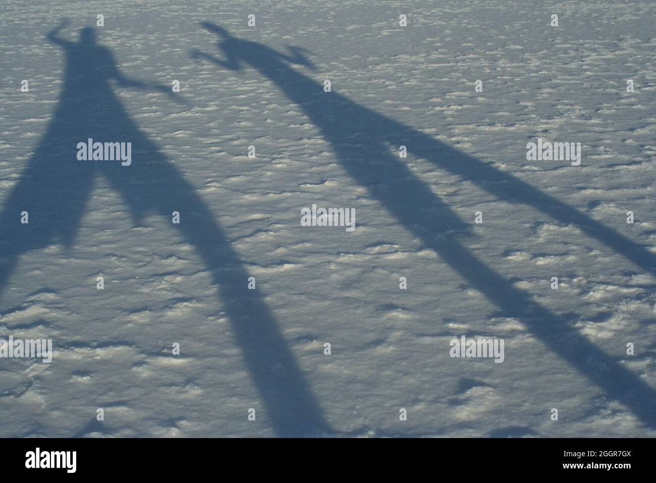 Tourists making shadow shapes in the salt surface of Salar de Atacama ...
