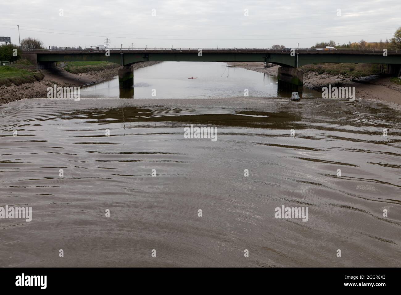 The Dee Tidal Bore approaching a bridge over New Cut channel between ...