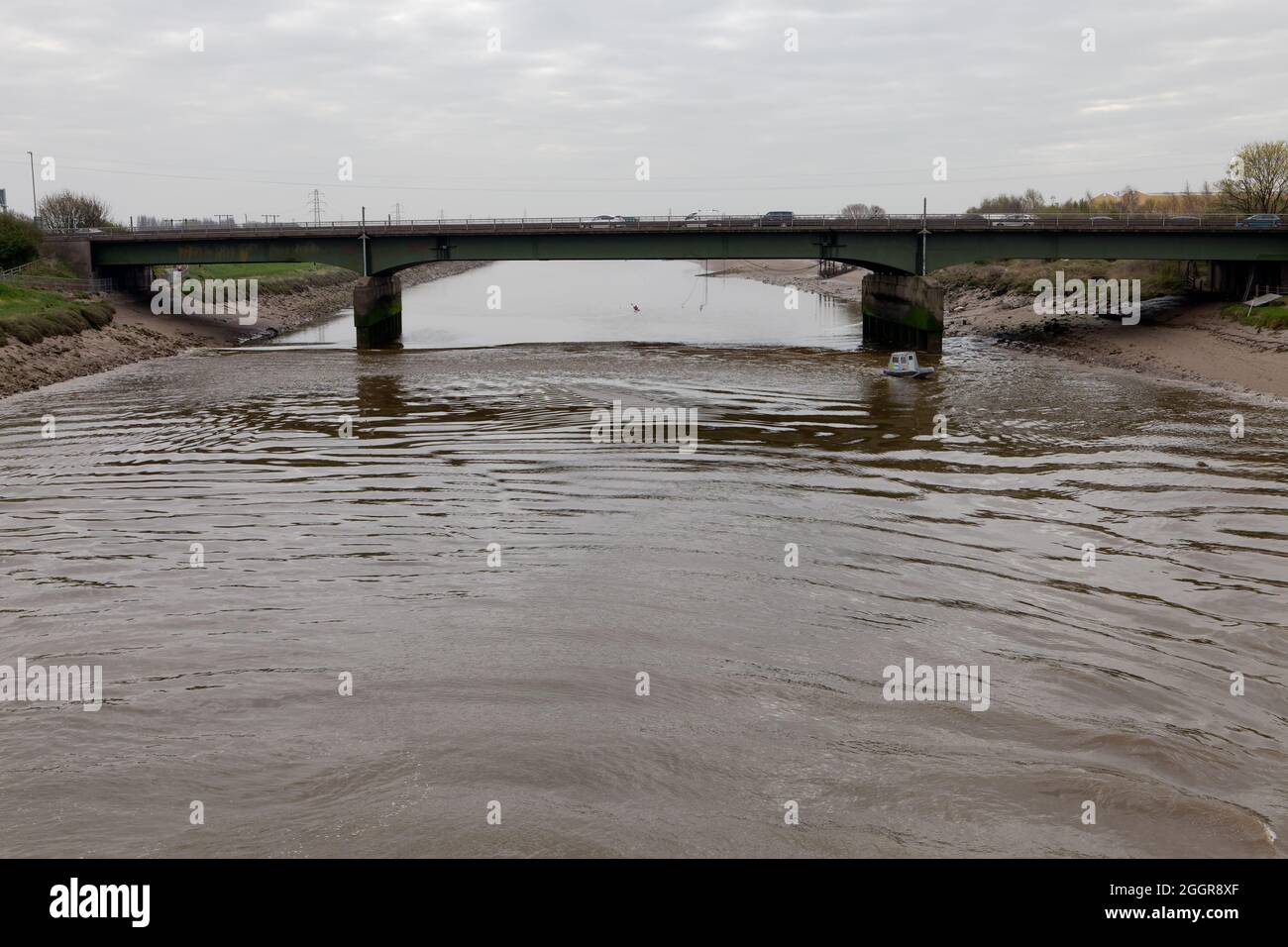 The Dee Tidal Bore approaching a bridge over New Cut channel between ...
