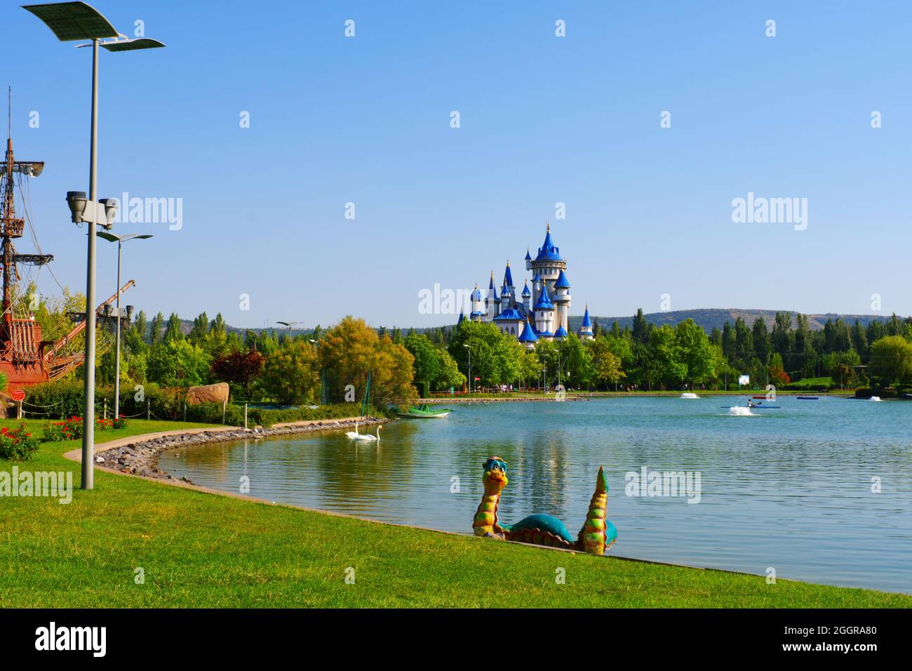 Wooden retro ship and vintage Fairytale castle lakeside at concept park ...