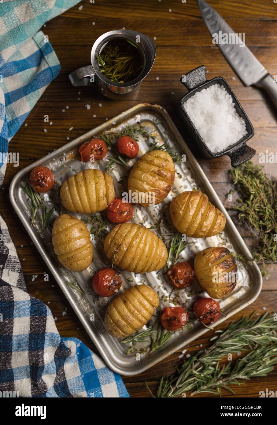 Vertical top view of potatoes and tomatoes baked in the oven with ...