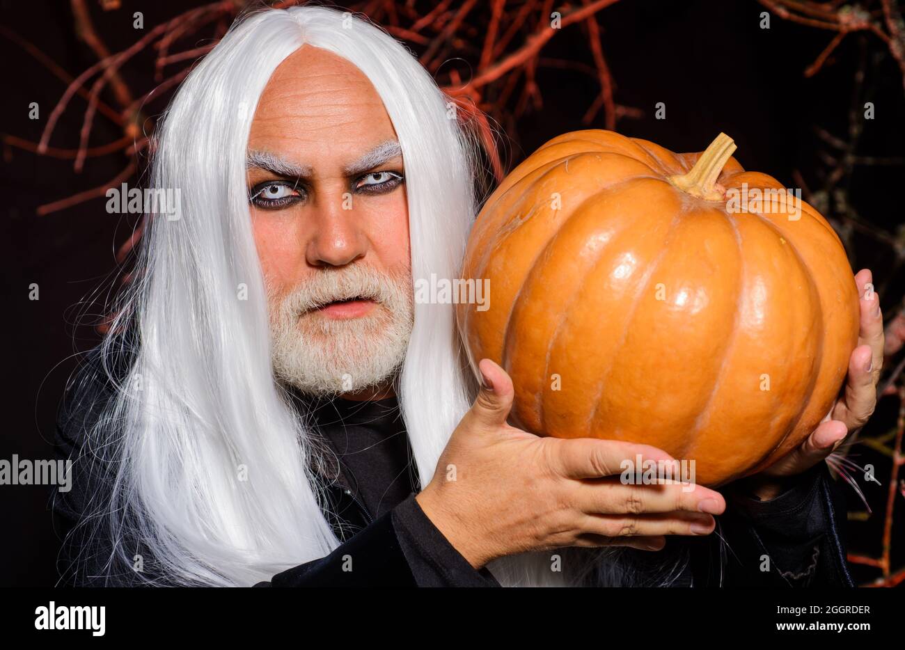 Devil man with Jack-o-lantern. Happy Halloween. Evil wizard with orange ...